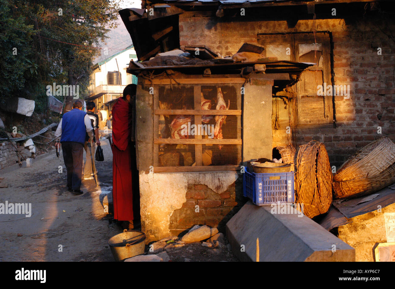 Tibetan Buddhist monk buying meat at a street stall in Dharamsala ...