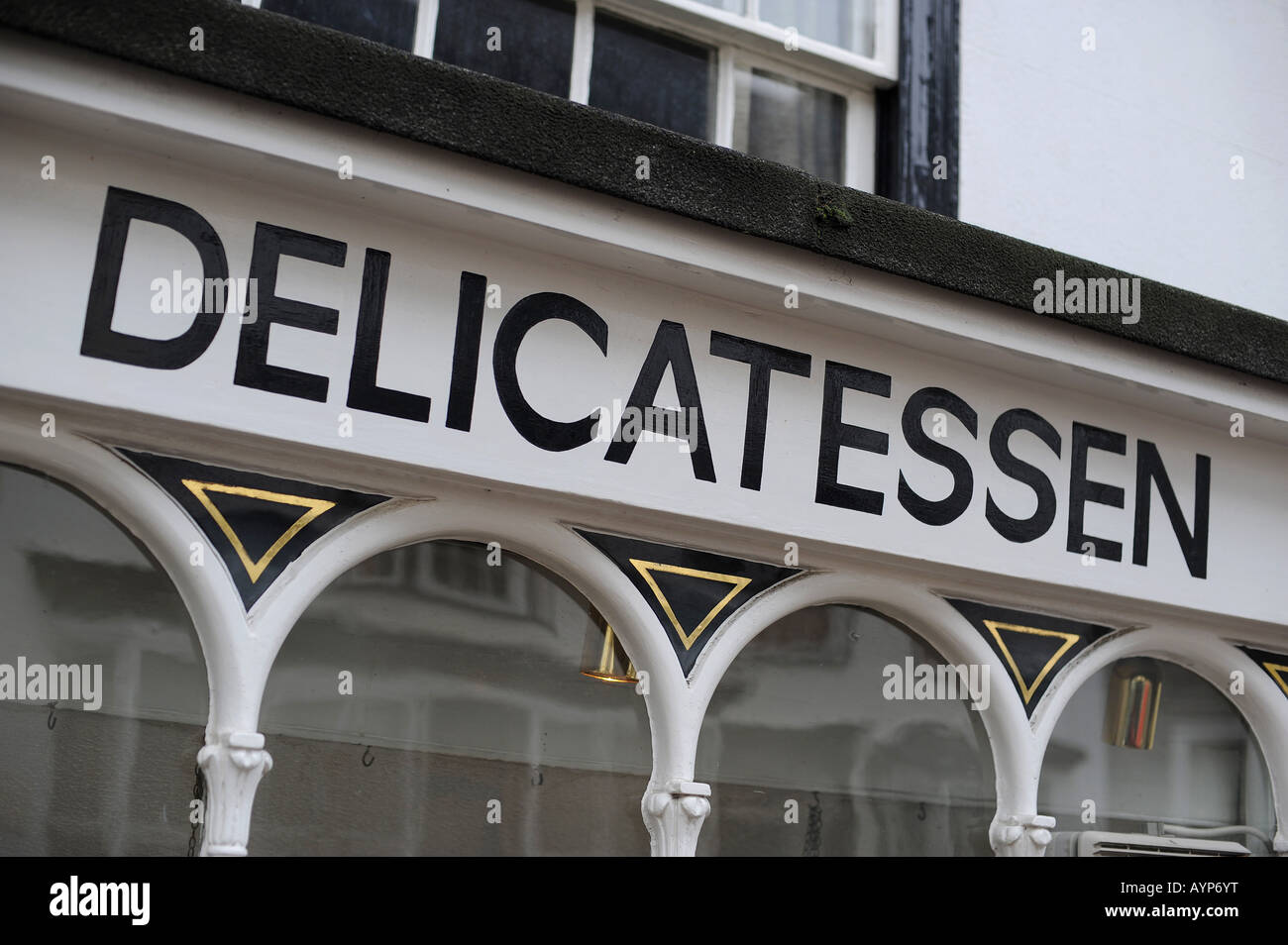 A delicatessen sign on a shop store in Modbury, Devon, UK Stock Photo ...