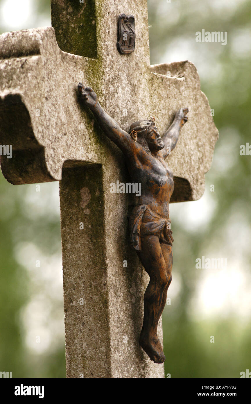 Old stone cross with rusty statue of crucified Jesus Christ Stock Photo ...