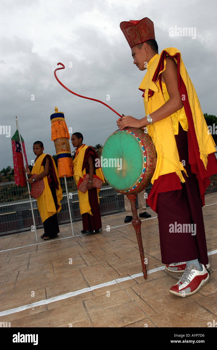 Tibetan buddhist monks playing traditional long trumpets during ...