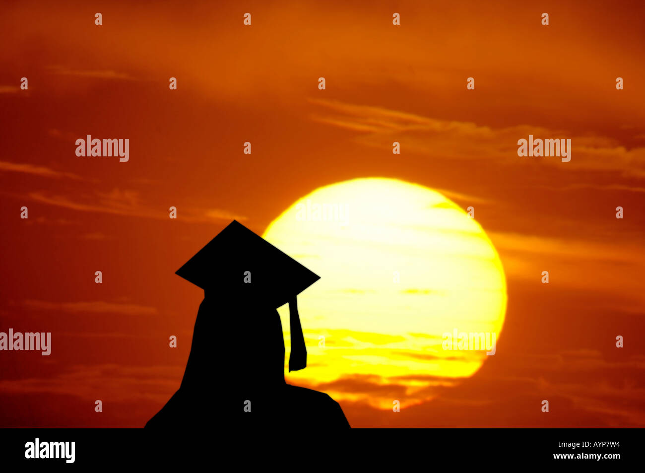 female college graduate wearing cap and gown at sunset Stock Photo - Alamy
