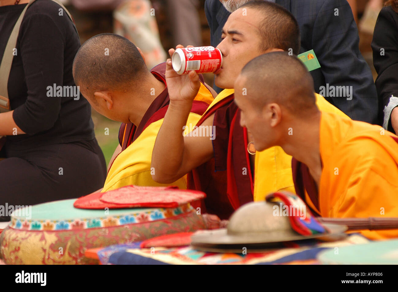 Young Tibetan buddhist monk drinking can of Coke during break of their ...