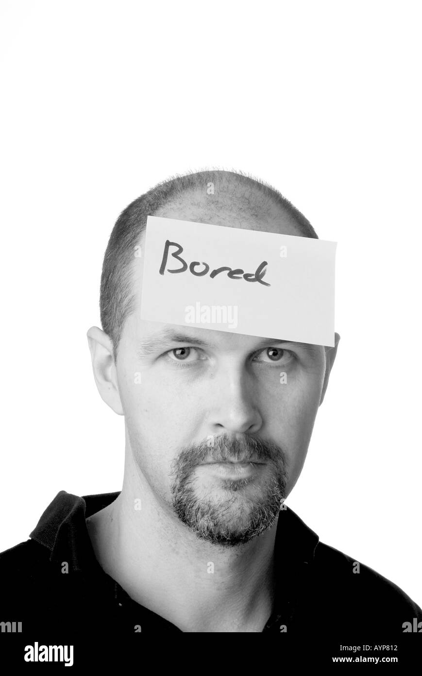 man with a post it note on his head representing that he is bored ...