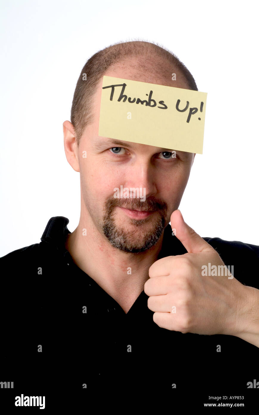 man with a post it note on his head representing that every thing is ok ...