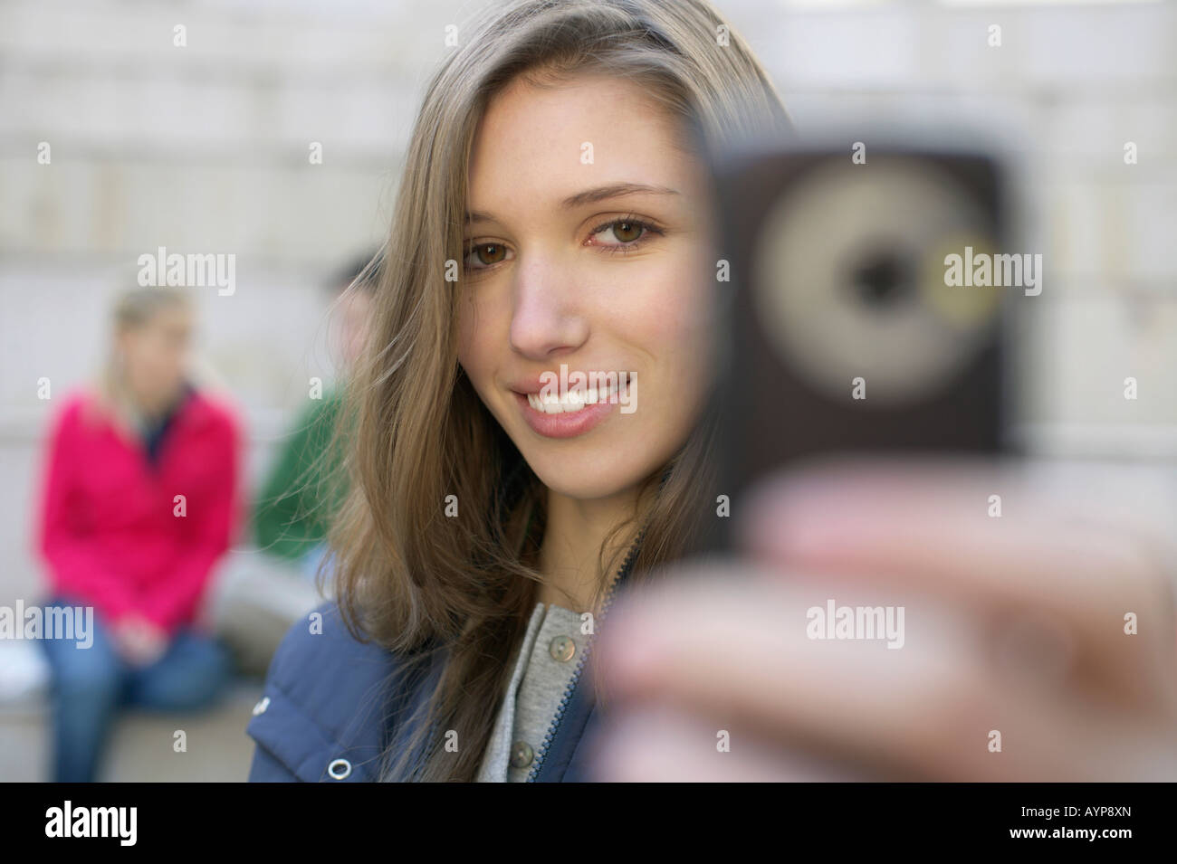 Young woman photographing herself with a mobile phone Stock Photo - Alamy