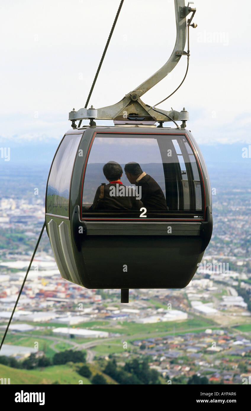 A couple enjoy the view over Christchurch from a cable car gondola ...