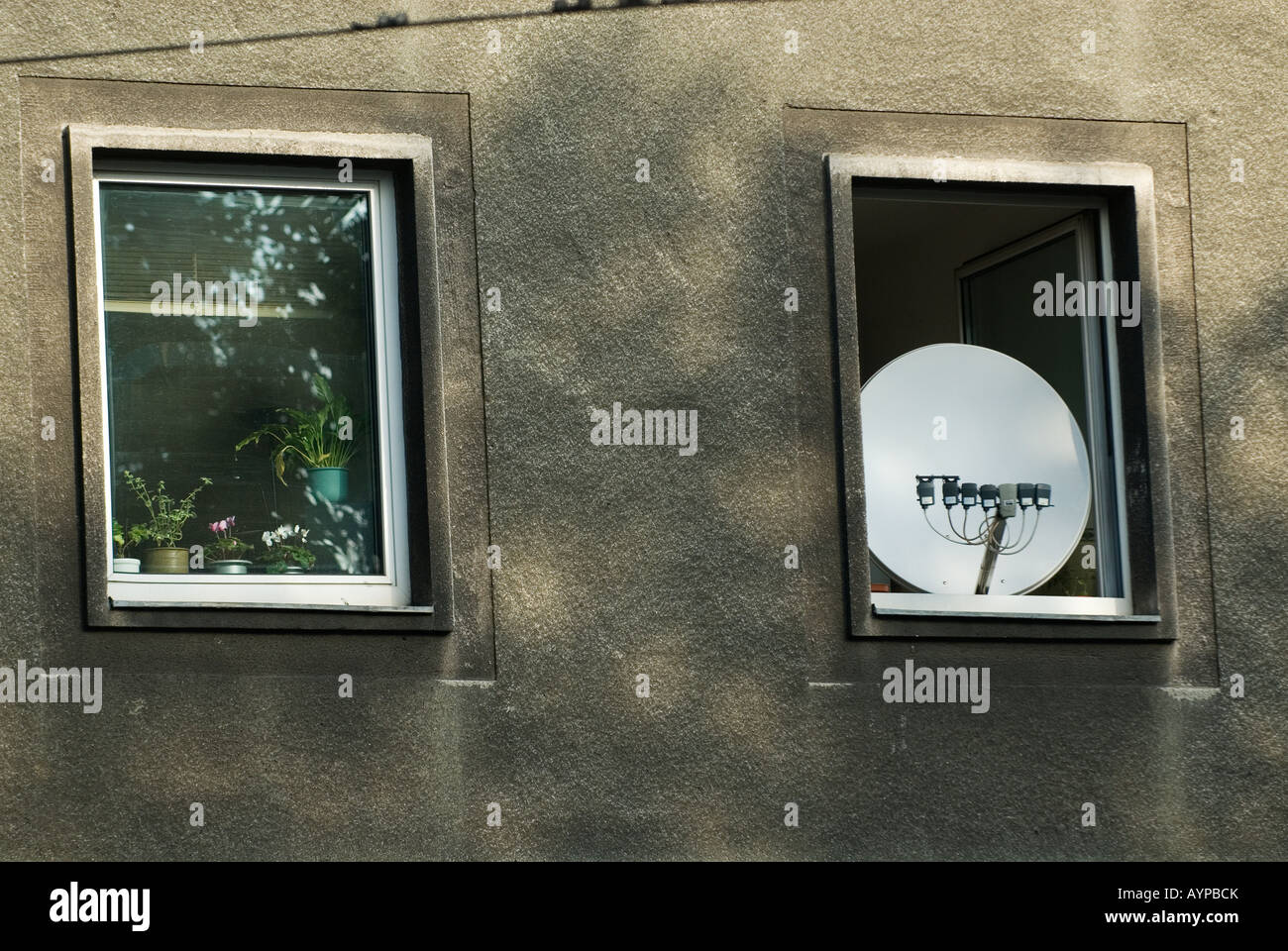 satellite dish with five LNBs in the open window of a residential ...