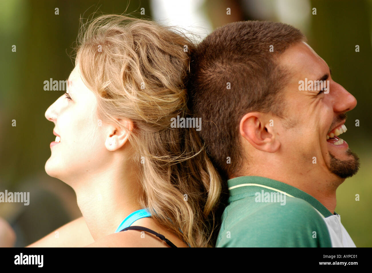 A couple facing opposite side smiling Stock Photo - Alamy