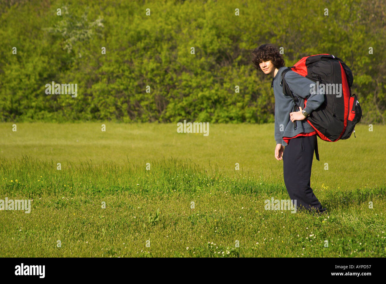 Teenager boy carrying glider in a backpack Stock Photo - Alamy