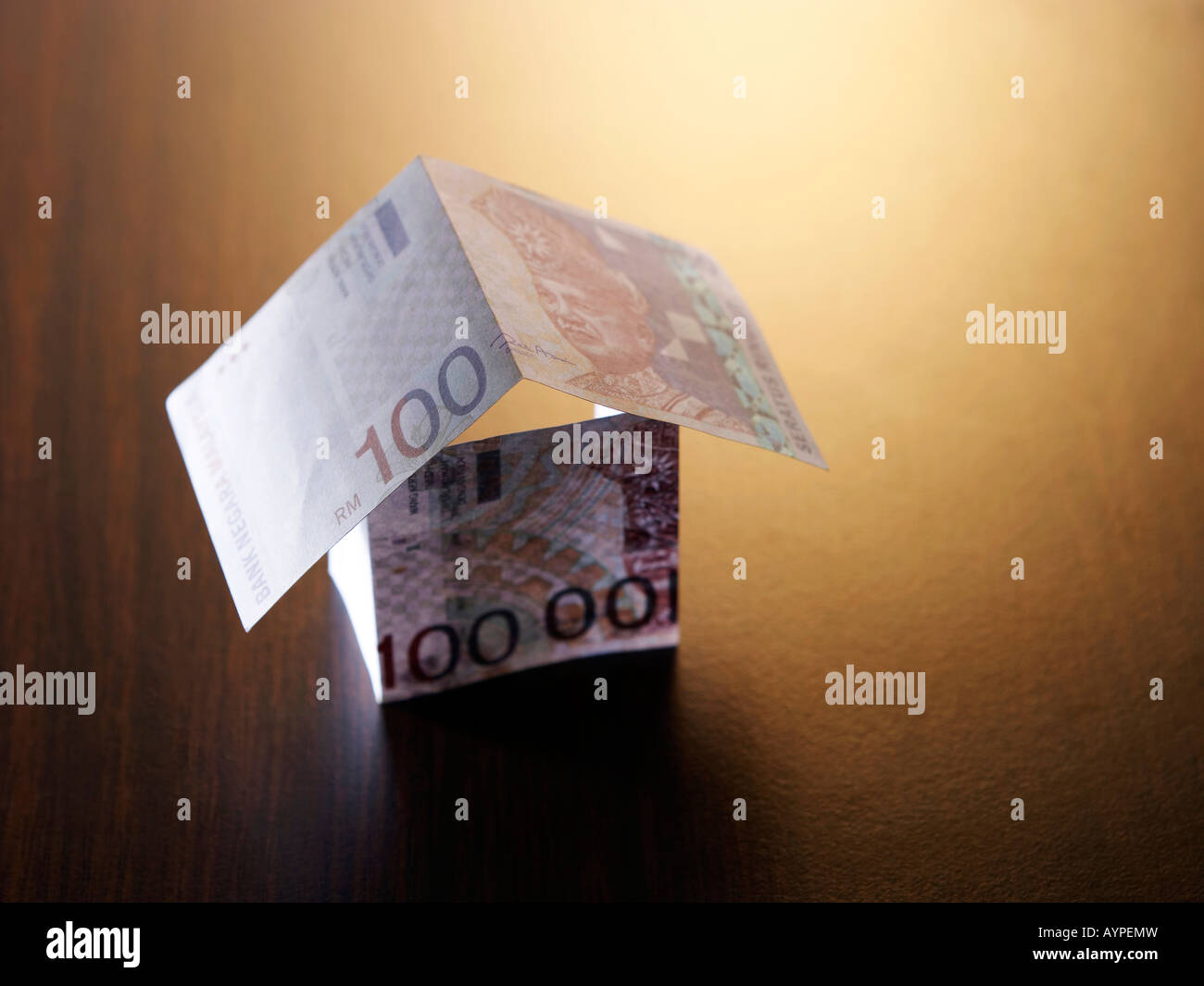 Top view of ringgit malaysia folded in shape of a home Stock Photo - Alamy
