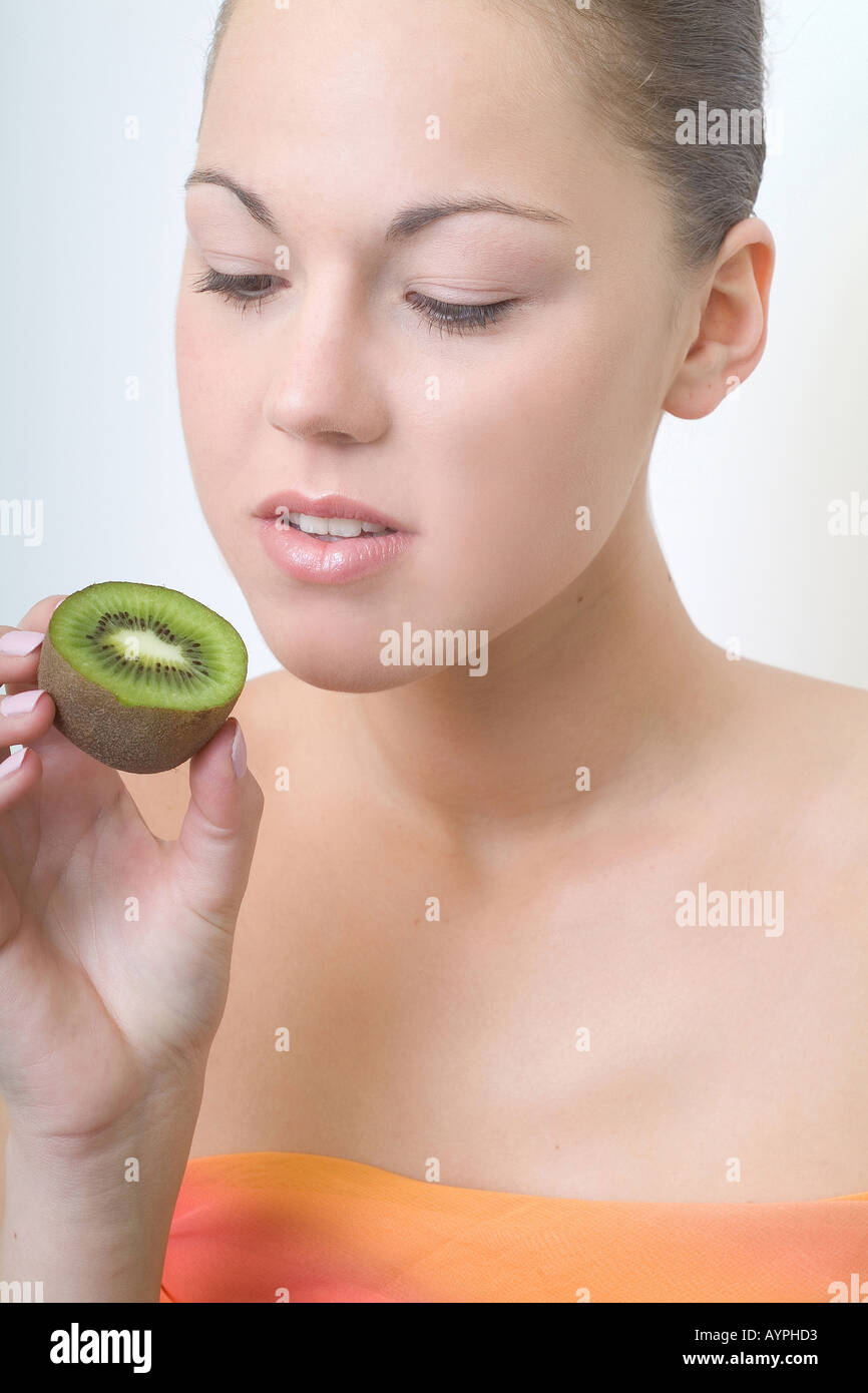 A teenage girl stares at the kiwi before eating it Stock Photo - Alamy