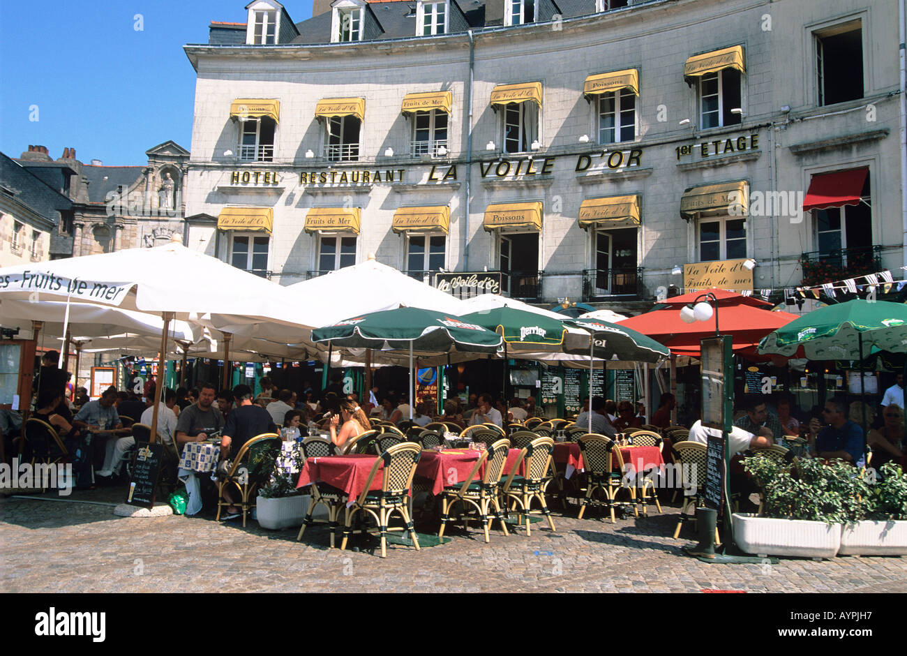 People eating and drinking at café terraces in Place Gametta at Vannes ...