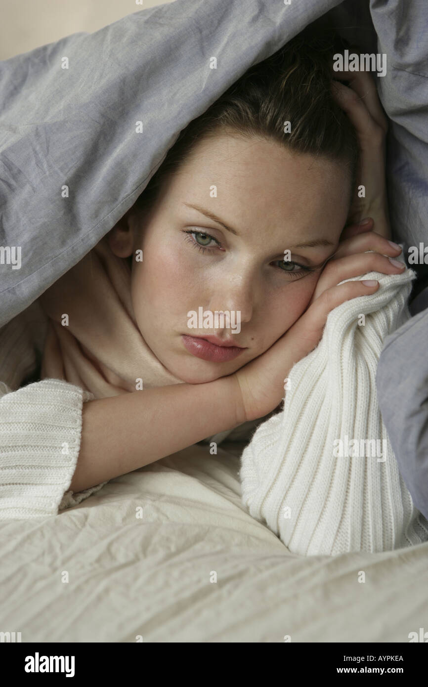 A young woman hiding herself under a blanket Stock Photo - Alamy