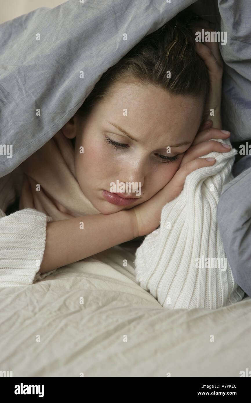 A young woman hiding herself under a blanket Stock Photo - Alamy