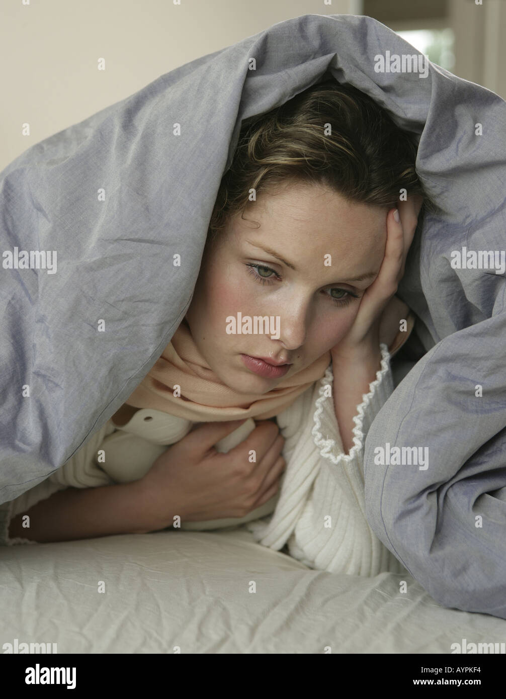 A young woman hiding herself under a blanket Stock Photo - Alamy