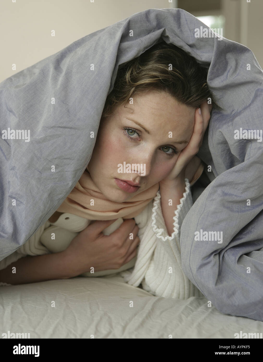 A young woman hiding herself under a blanket Stock Photo - Alamy
