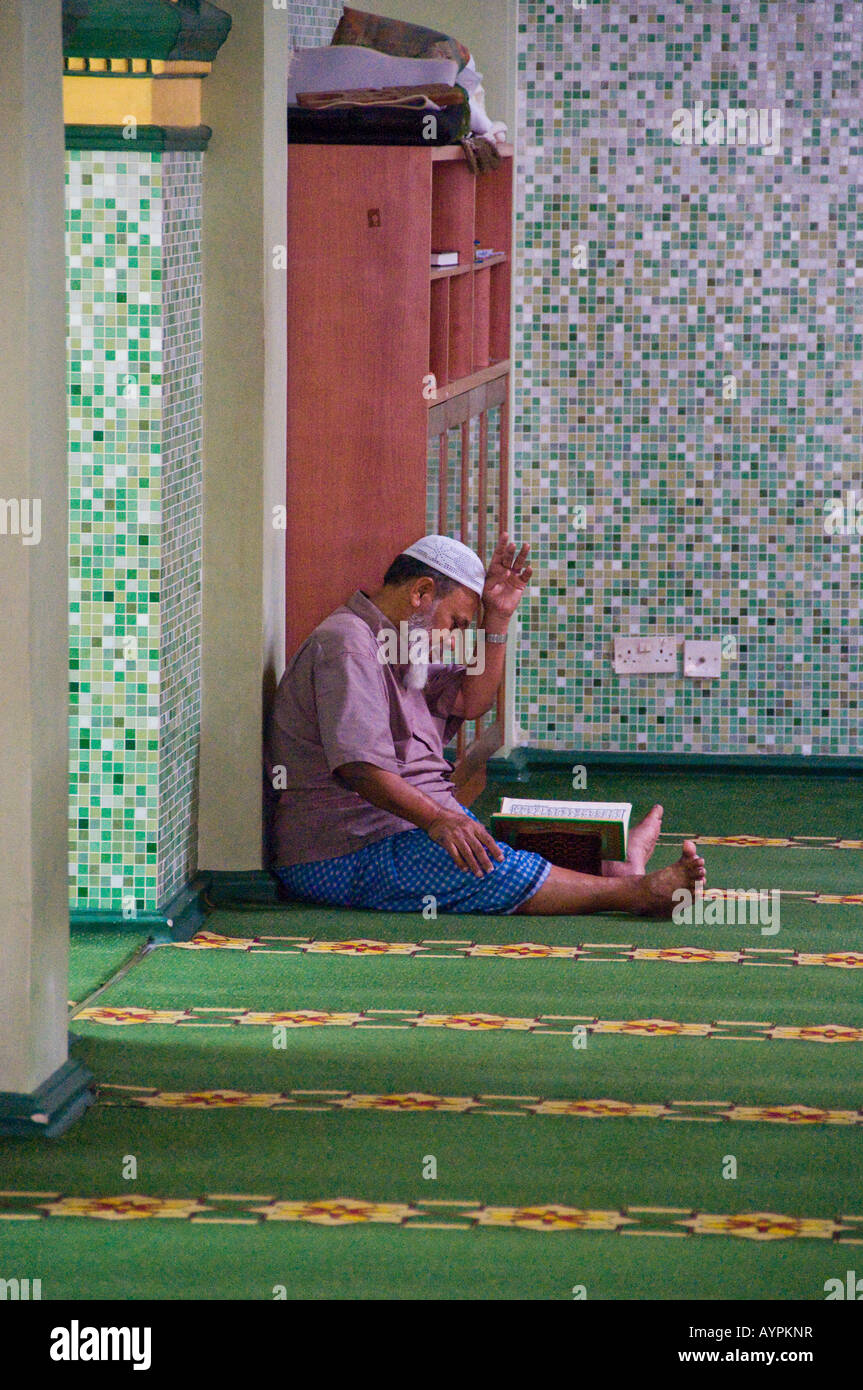 Muslim man sitting in prayer hall at Masjid Abdul Gafoor Mosque in ...