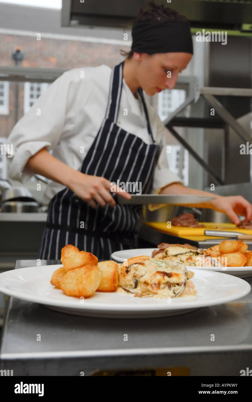 Young Female chef plating food Stock Photo - Alamy