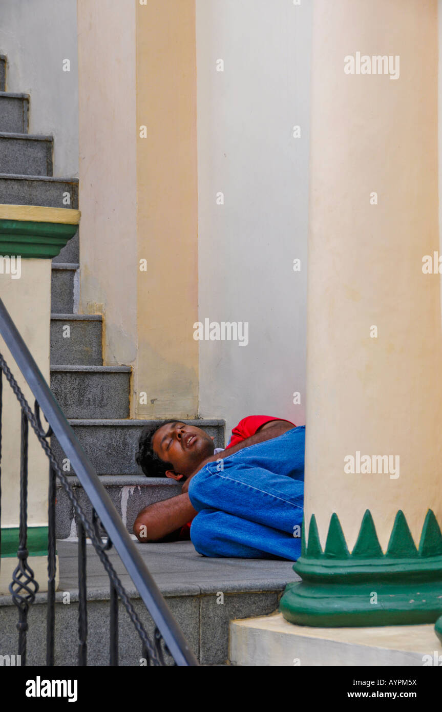 Muslim worker sleeping on steps outside Masjid Abdul Gafoor Mosque in ...
