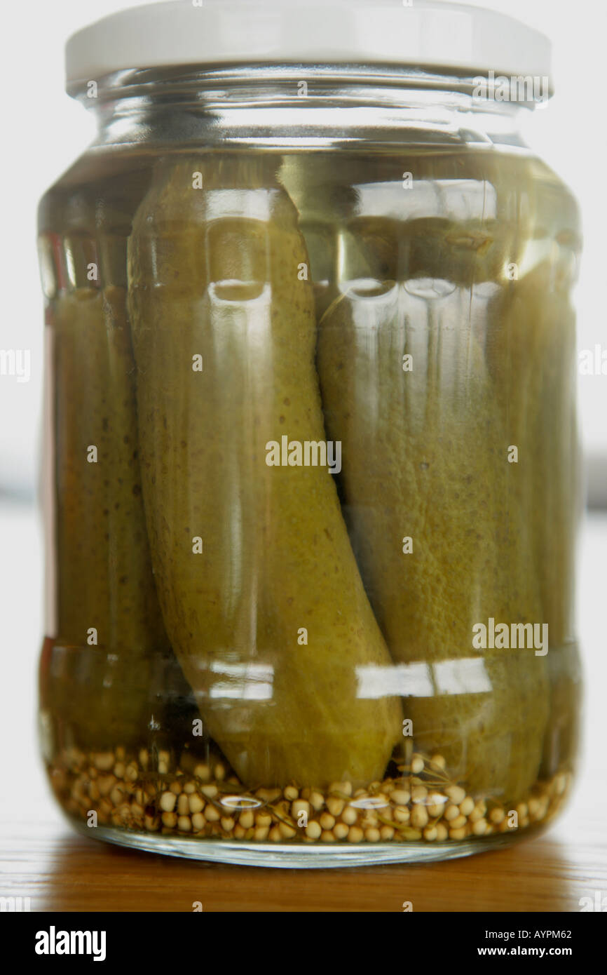 Some gherkins packed in a glass jar Stock Photo - Alamy