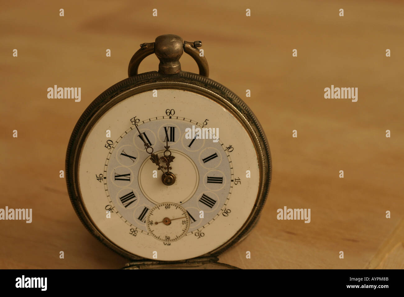 An antique pocket watch with Roman numbers on the dial is seen on the ...