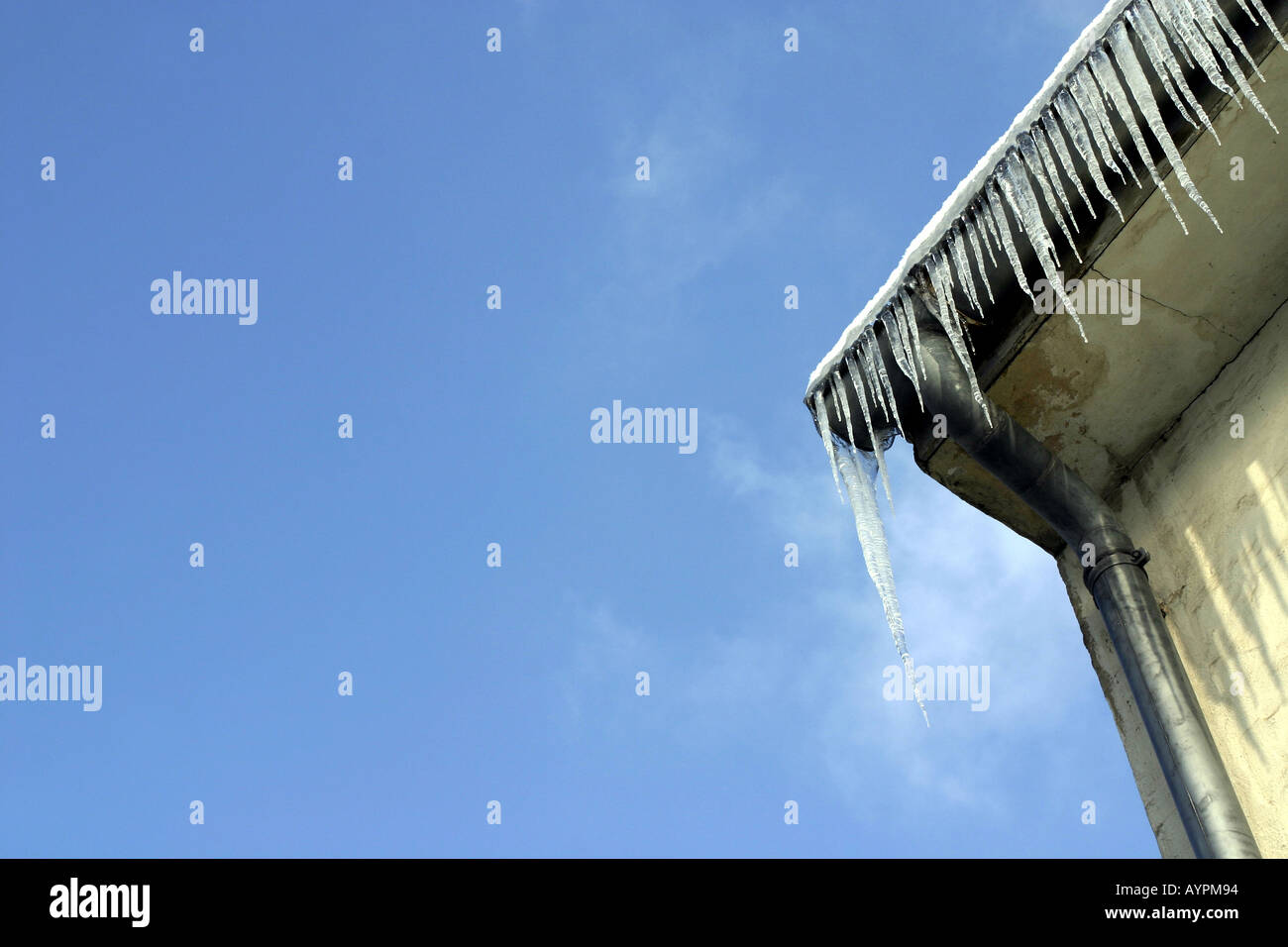 A section of a building with frozen ice on the roof is seen under the ...