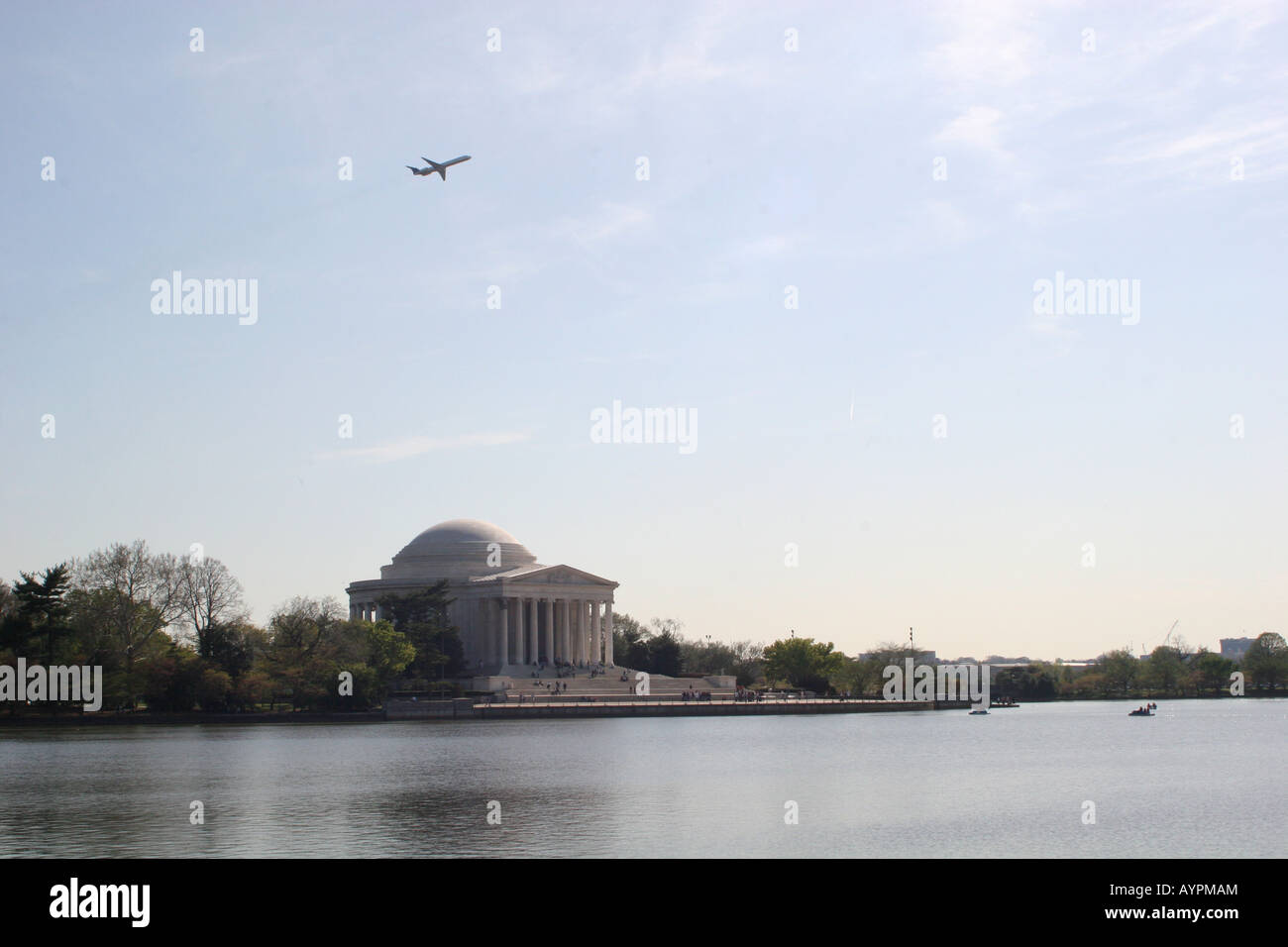 Airplane flying over the Jefferson Memorial from across the Tidal Basin ...