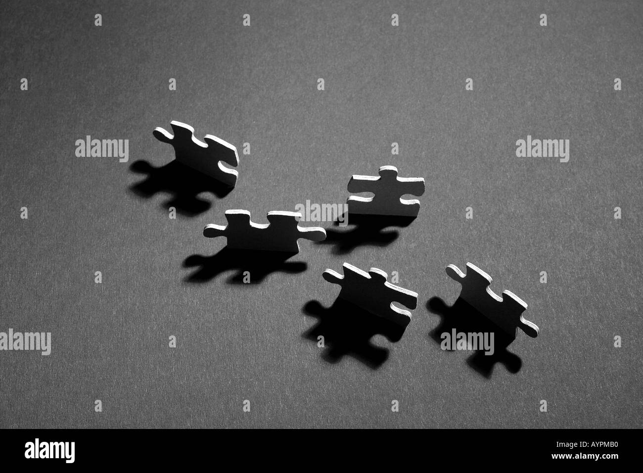 Five fragments of a puzzle having different shapes are placed upright ...