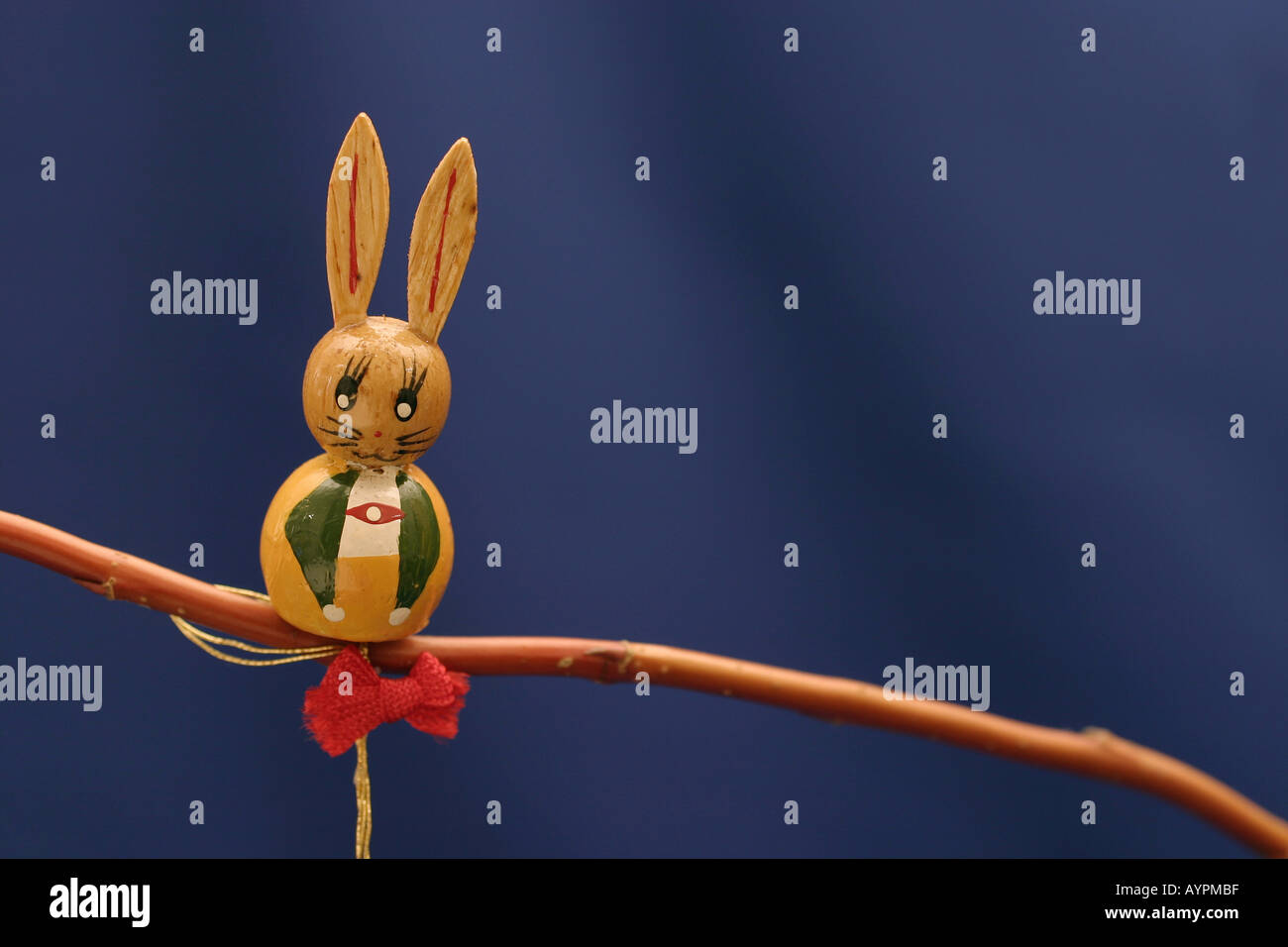A small wooden bunny rabbit is tied on a thin stem Stock Photo - Alamy