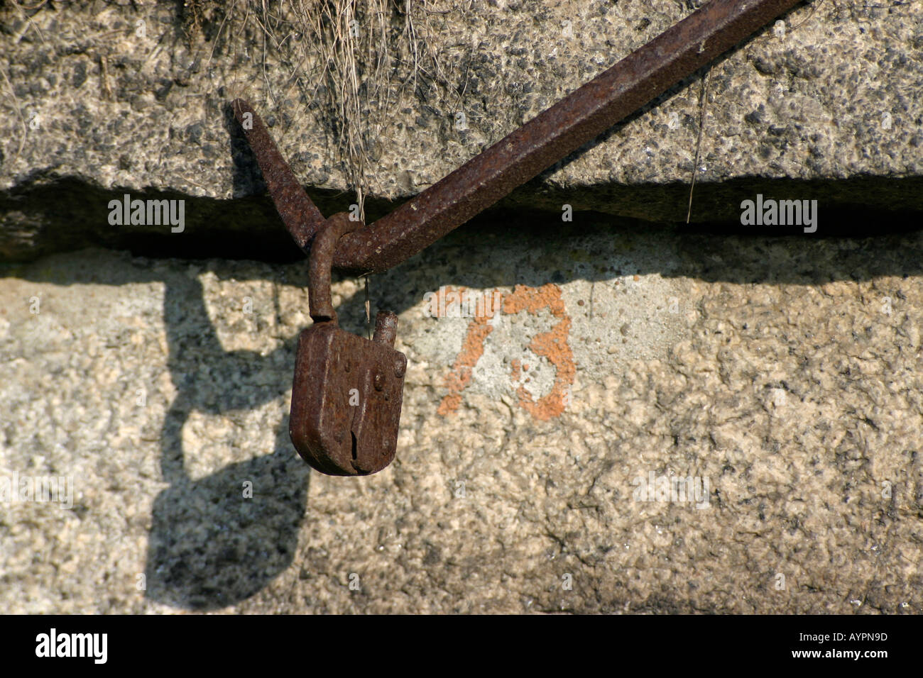 A broken iron lock hung on metal rod Stock Photo - Alamy