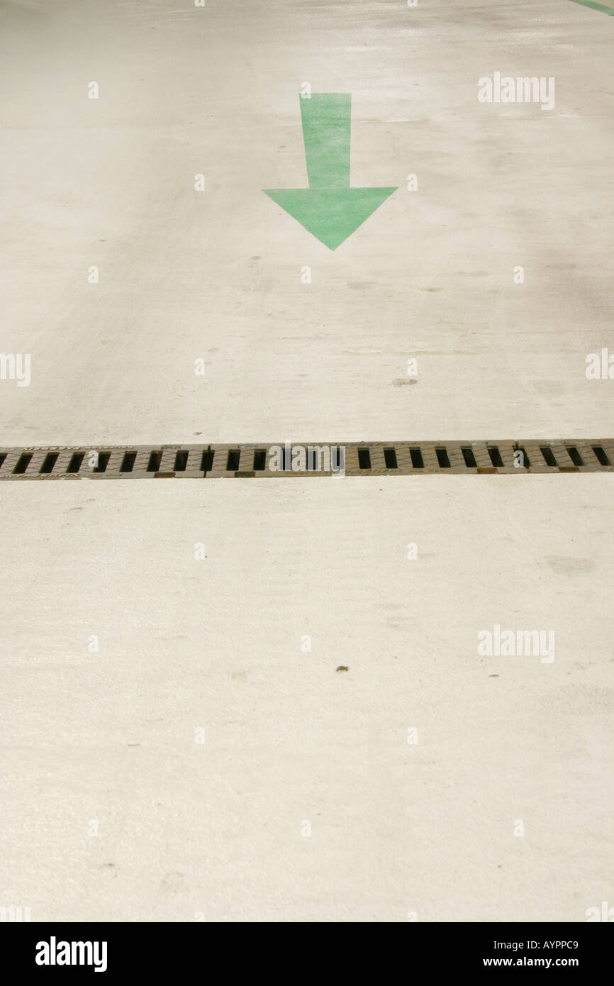 An arrow showing One Way direction in the parking space Stock Photo - Alamy