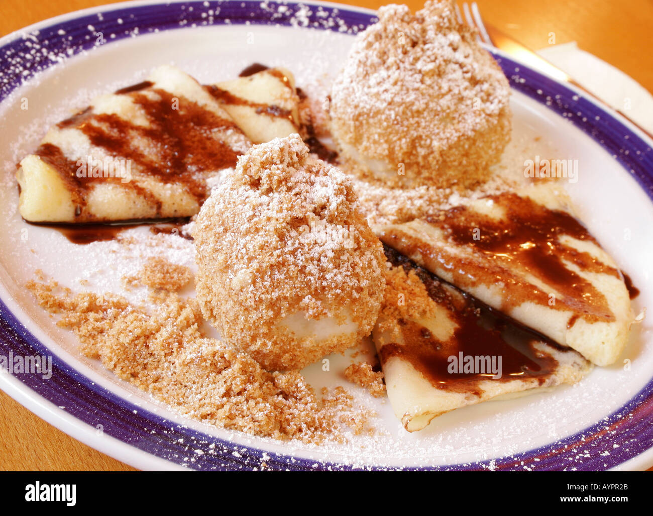 A tempting dish with chocolate topping and powdered sugar Stock Photo ...