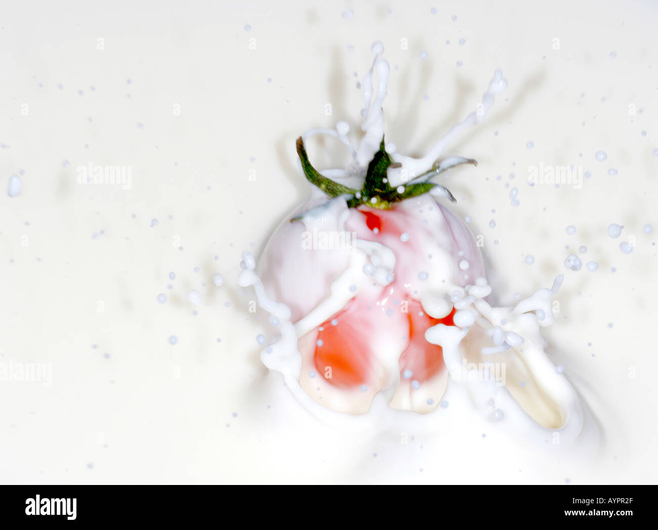 A picture of tomato splashing into the milk Stock Photo - Alamy