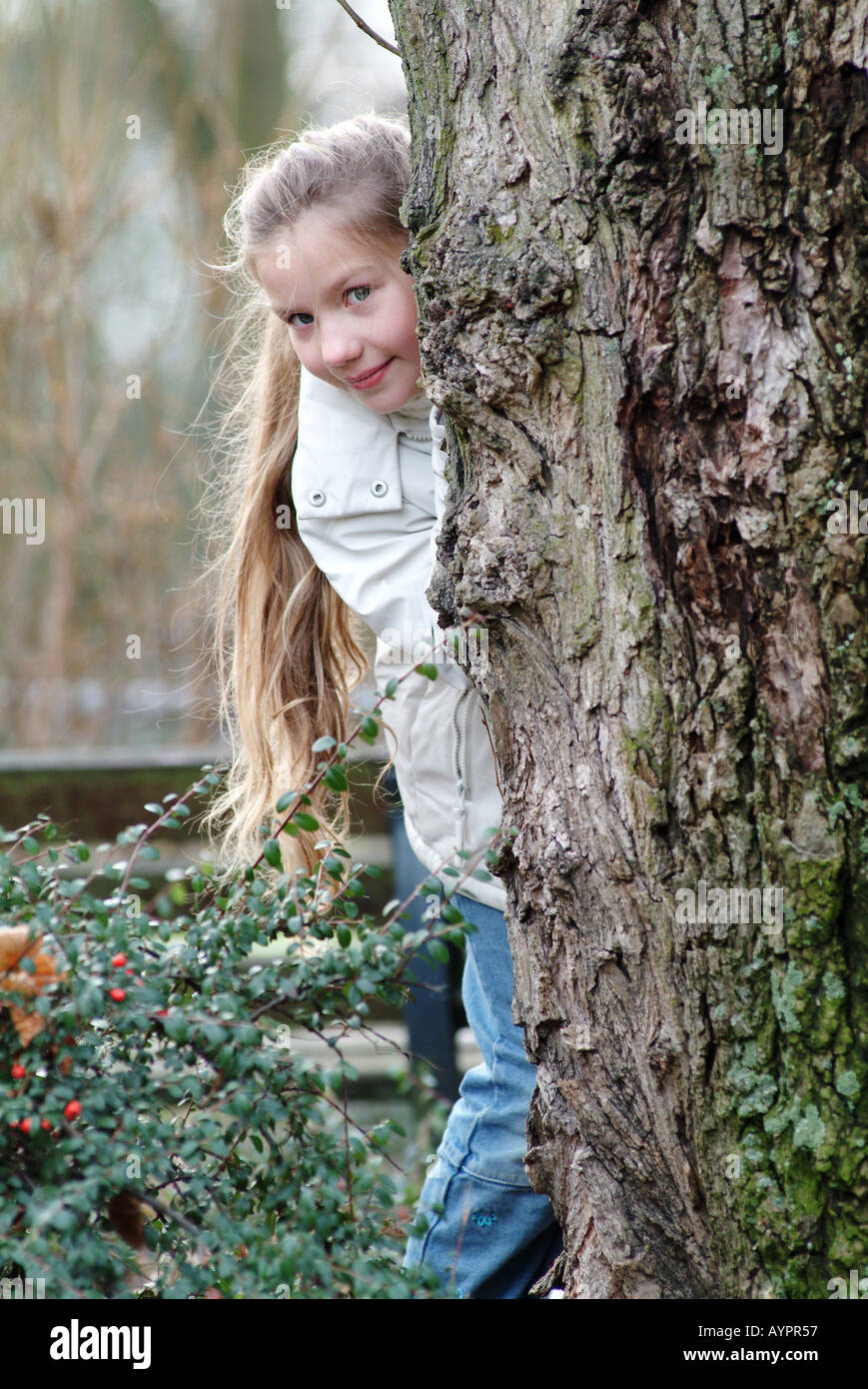 Girl hiding behind bushes hi-res stock photography and images - Alamy