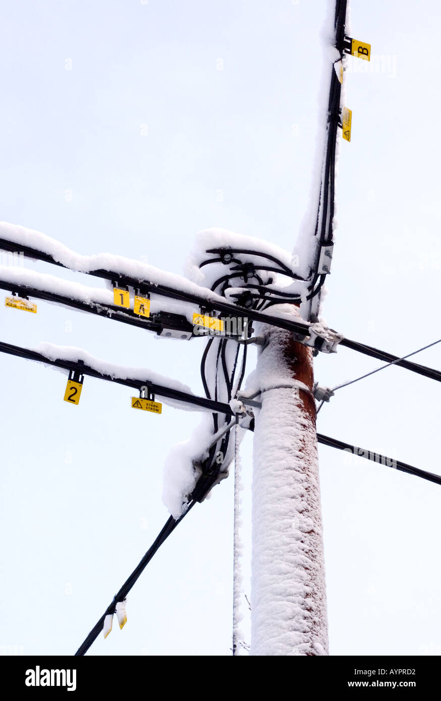 Snow power lines cable pole Stock Photo - Alamy