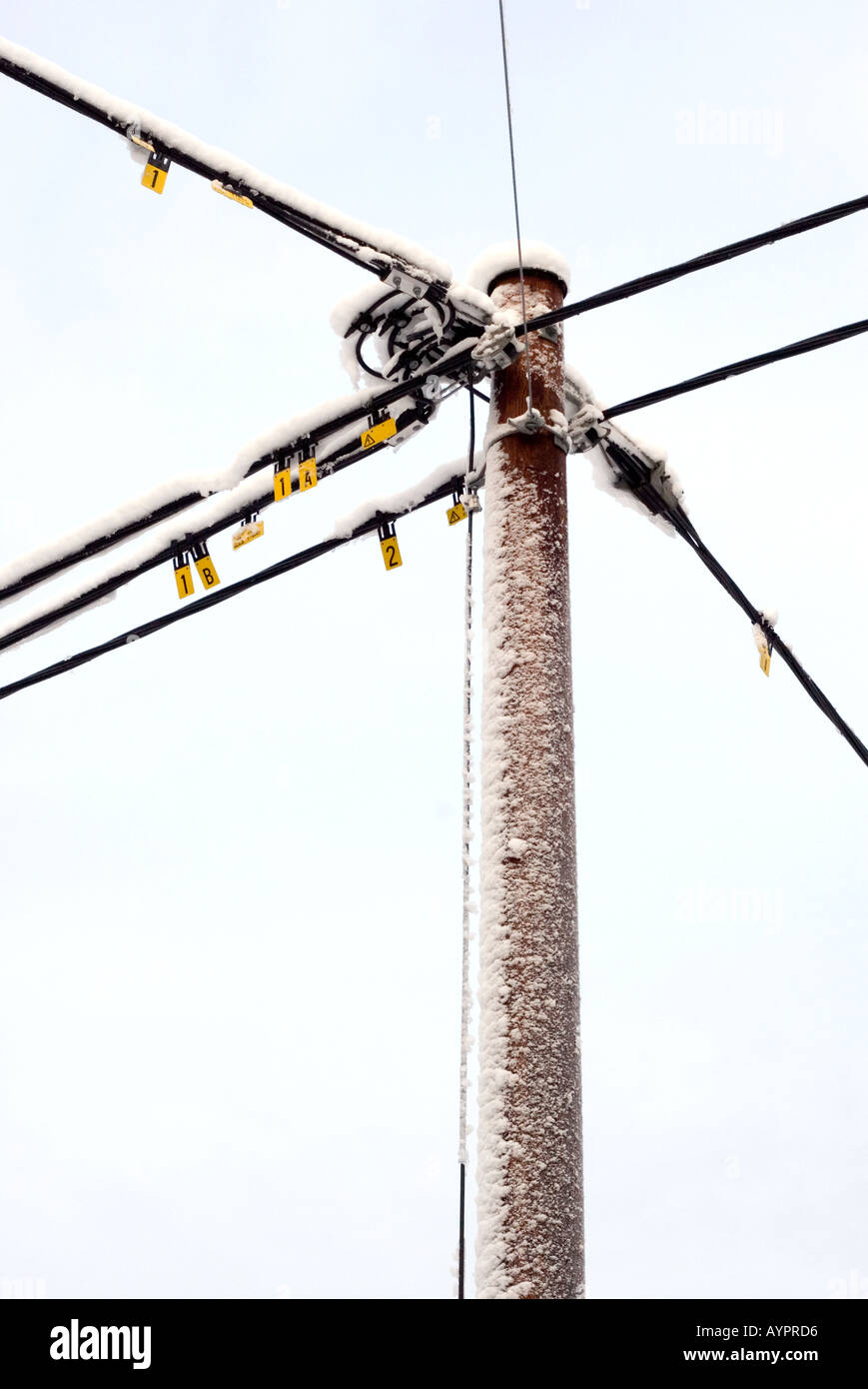 Snow electric power lines cable pole Stock Photo - Alamy