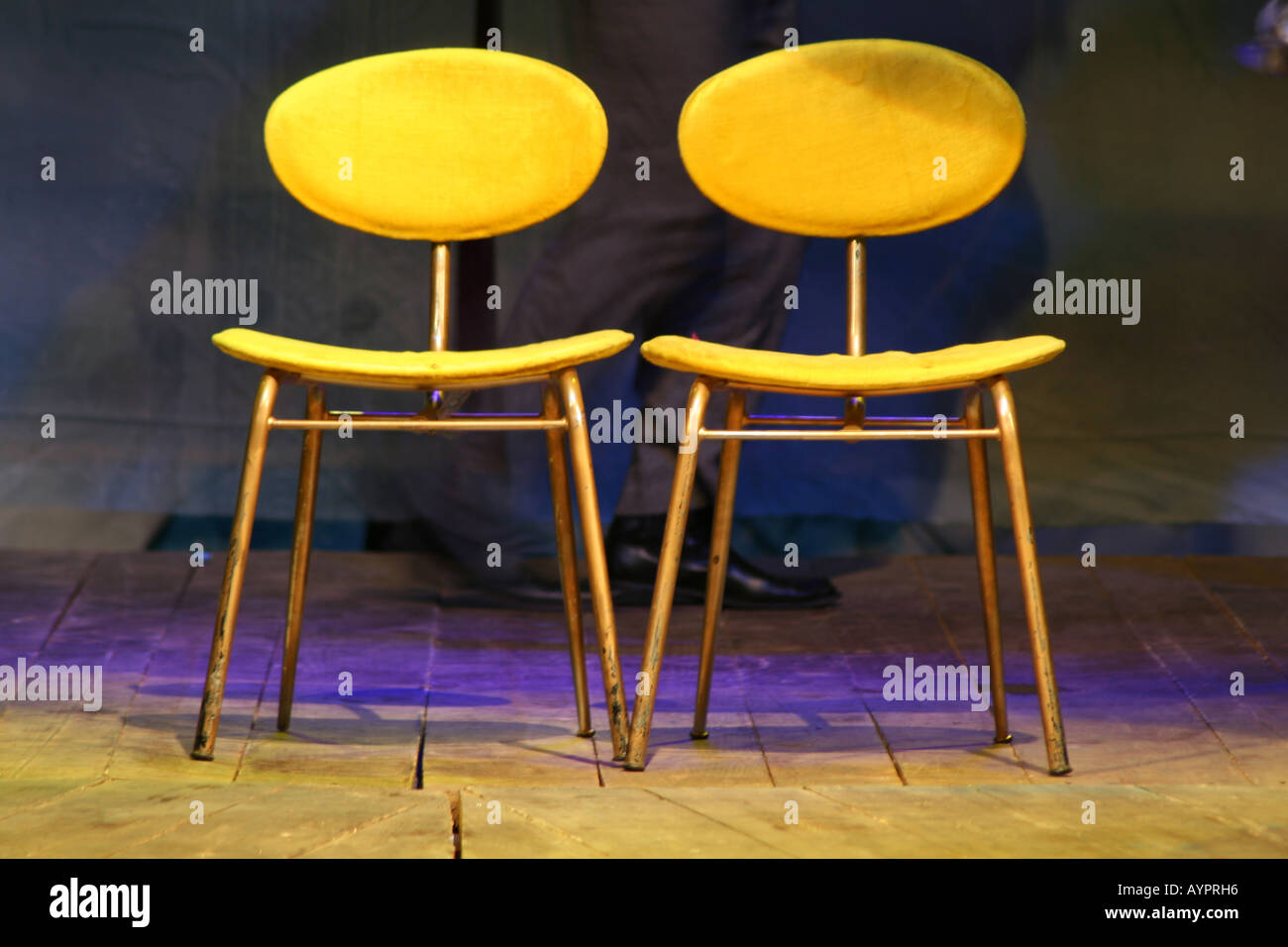 two yellow chairs on stage Stock Photo - Alamy