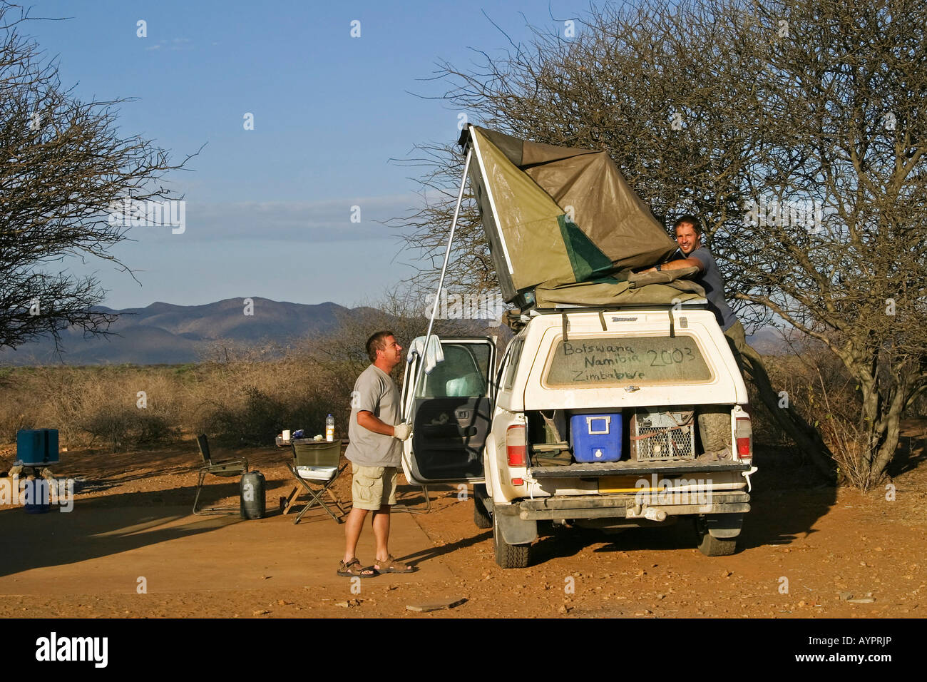Setting up camp, setting up a tent at a campsite at Okapuka Ranch ...