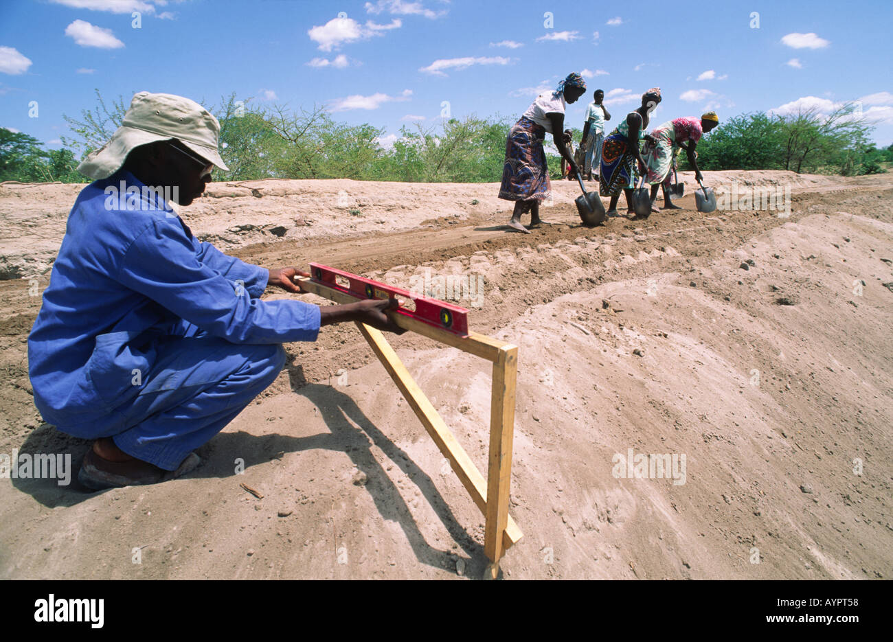 Local volunteers working on a community small-scale dam-building ...