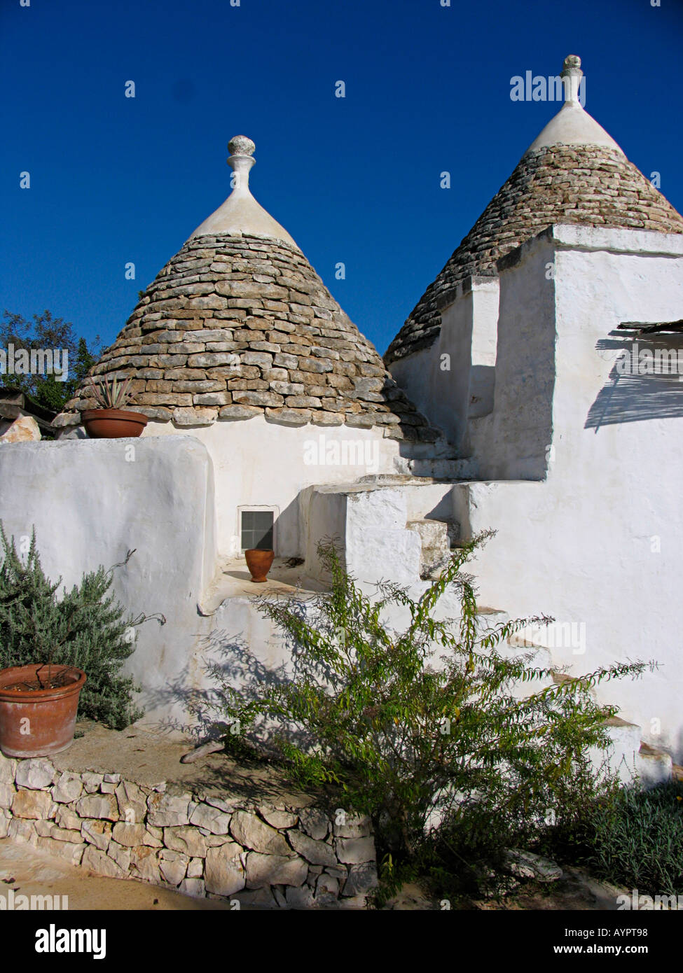 A traditional conical-roofed trullo house in Puglia, southern Italy ...