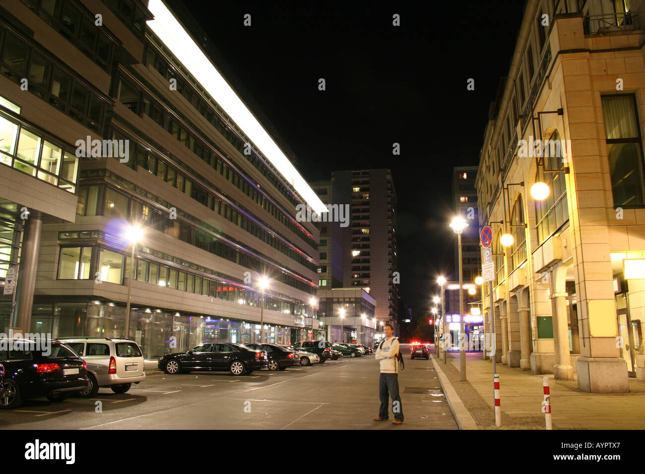 lonely street at night with man just standing Stock Photo - Alamy