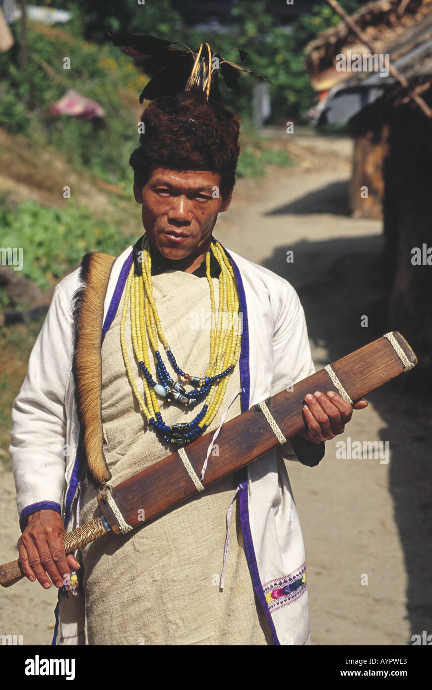 AJI74567 Dao large knife in mans hands Miji tribe man with traditional dress Arunachal Pradesh ...
