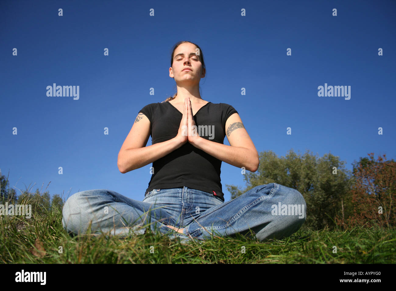 lady meditating in prayer position Stock Photo - Alamy