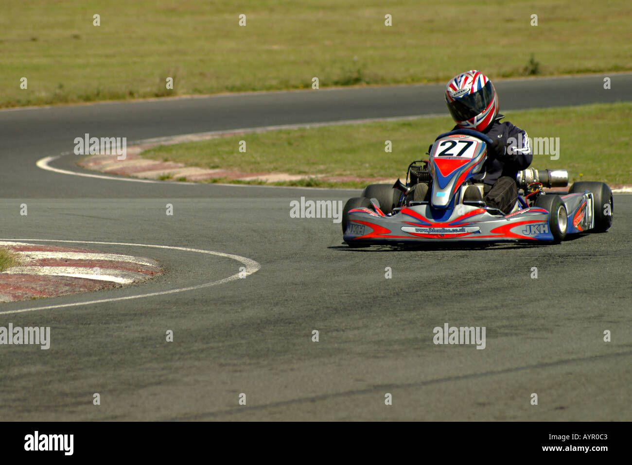 Go-Kart driver racing on a circuit Stock Photo - Alamy