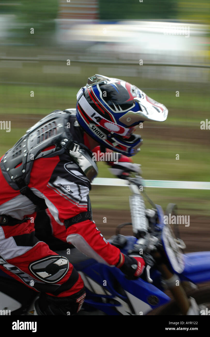 Motocross rider at speed with movement riding a motorcycle Stock Photo ...