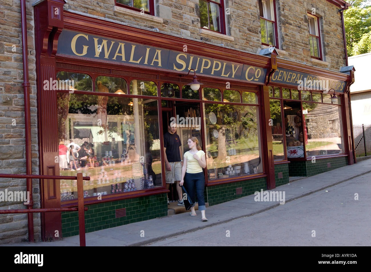 Tourist leaving heritage Gwalia Supply shop in Museum of Welsh Life St ...