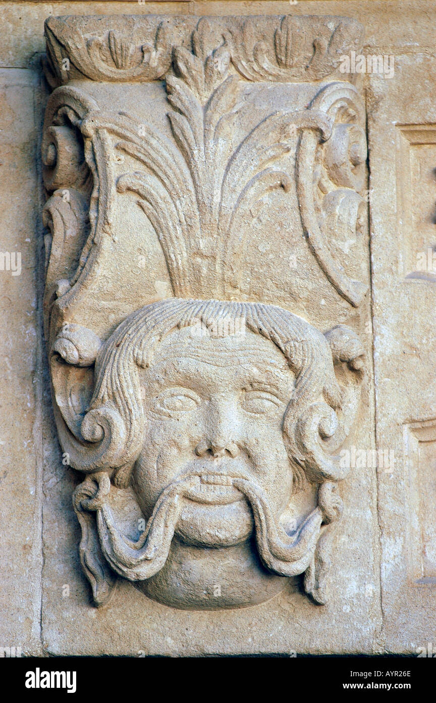 Architectural stone carving of a face with mustache, decorative detail ...
