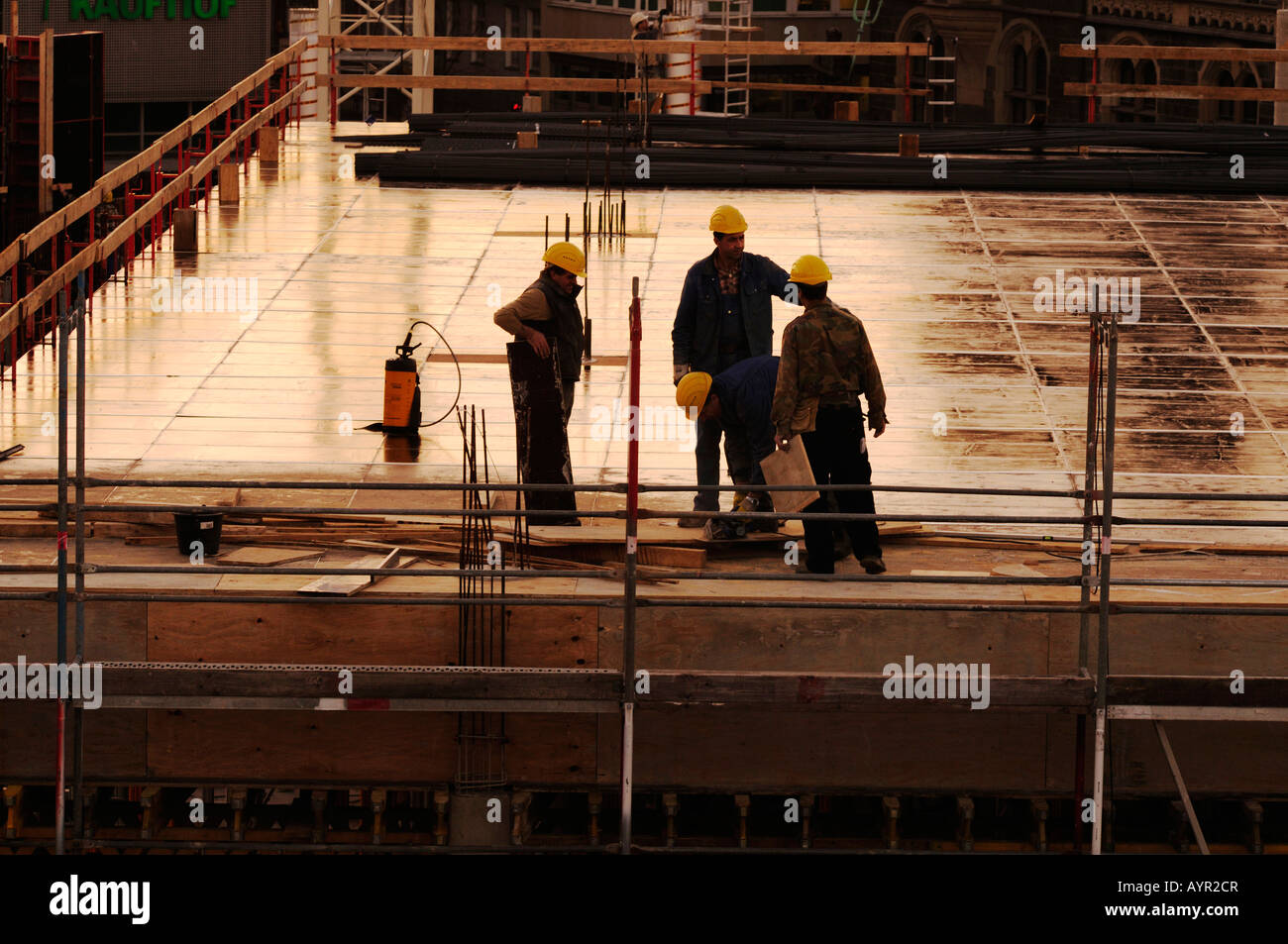 Construction workers talking at a construction site, building shell ...