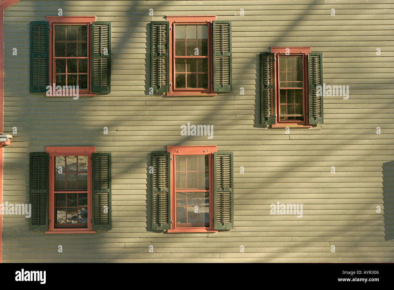 An exterior wall windows and shutters of an old house built in the 1850 ...