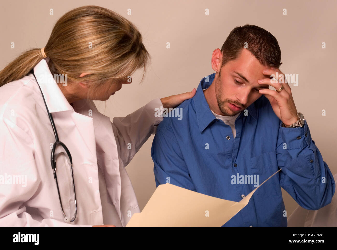 Female GP gives male patient bad report Stock Photo - Alamy
